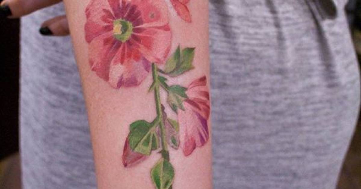 Illustrative malva tattoo on the right inner forearm.