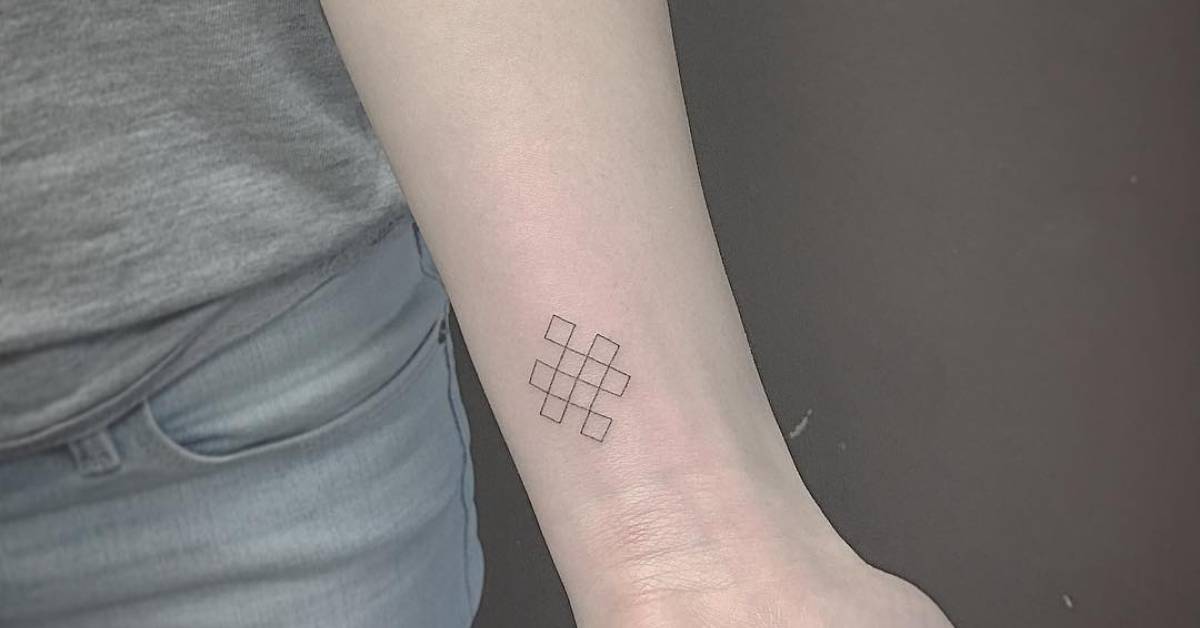 Fine line style endless knot tattoo on the left inner