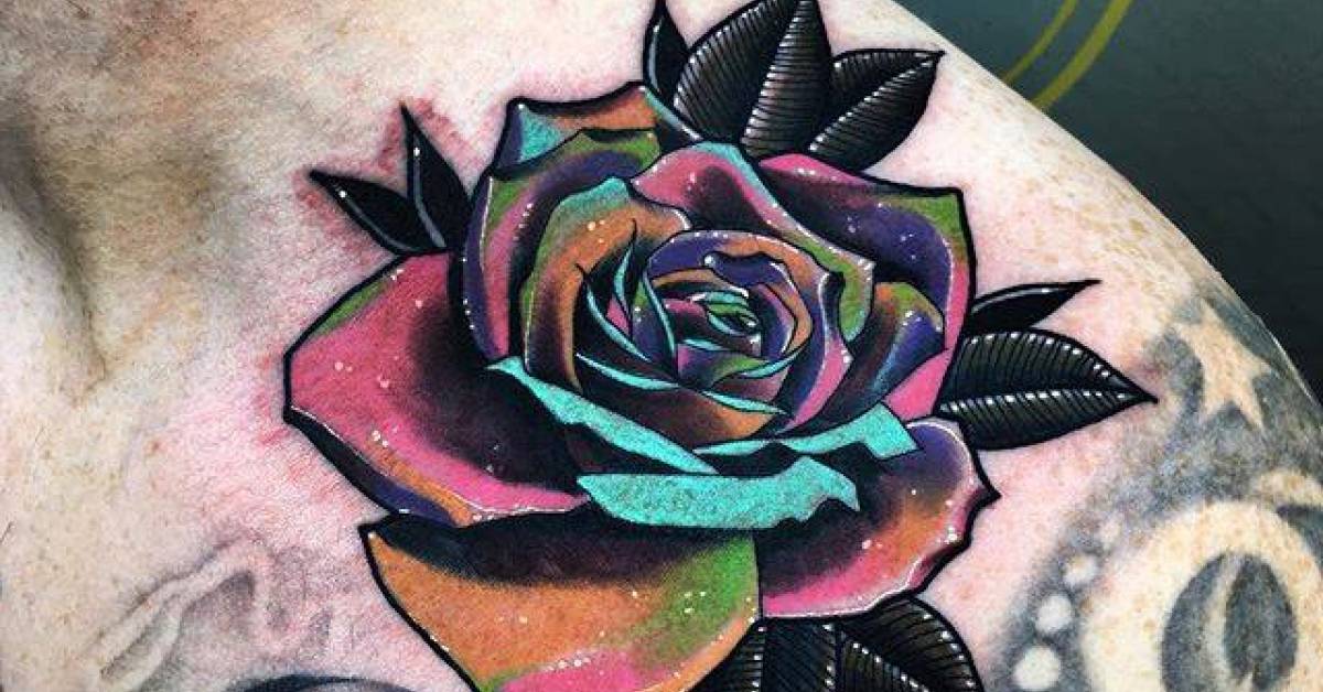 Psychedelic rose tattoo on the left collarbone.