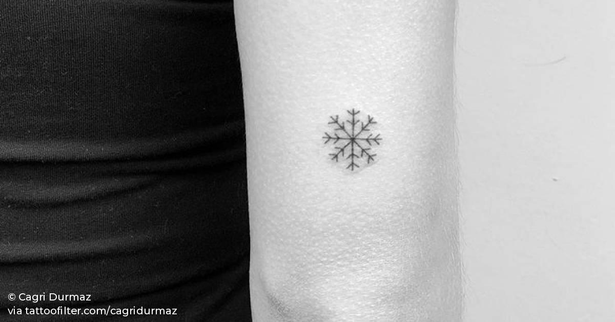 Snowflake tattoo on the back of the right arm.