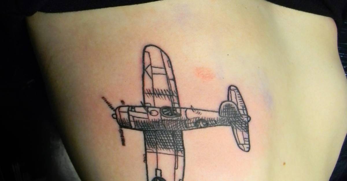 Side tattoo of an airplane by Craigy Lee.