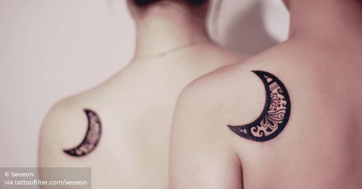 Matching moon tattoo on a couple's shoulder blade, by