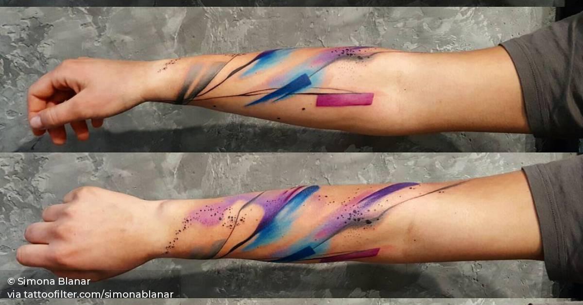 Abstract tattoo on the right forearm.