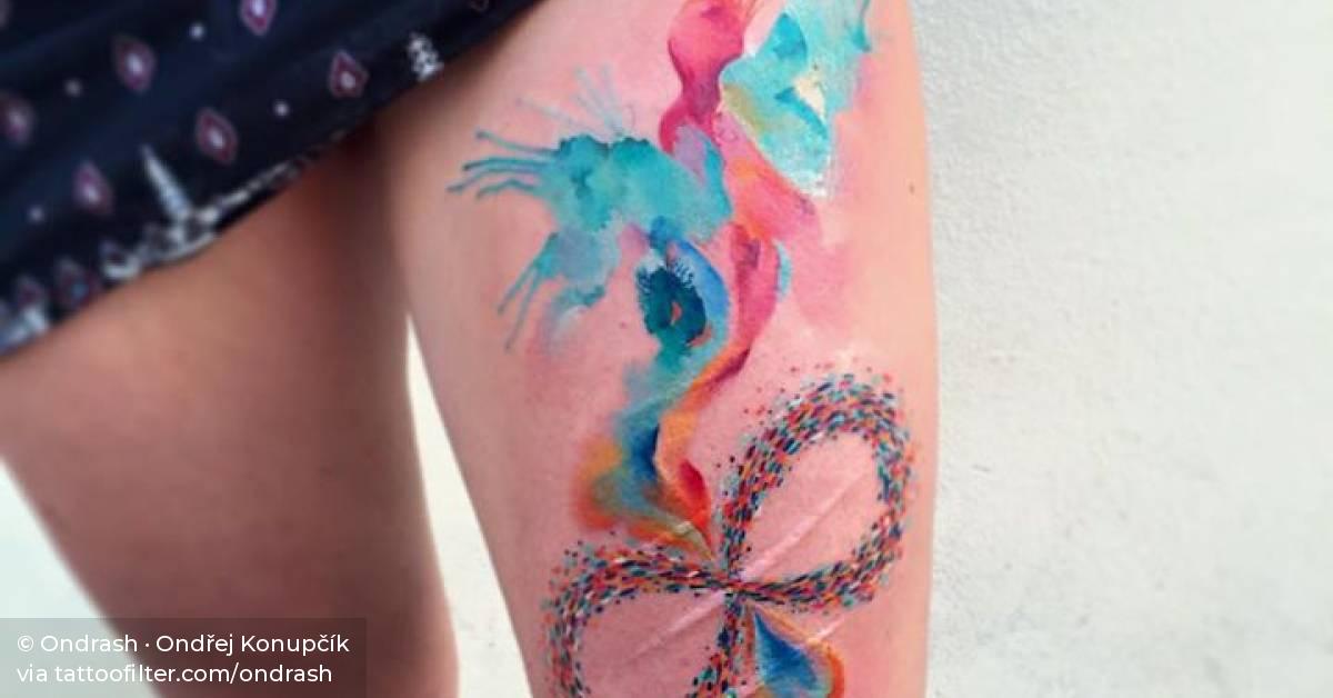 Abstract tattoo on Sabine's left thigh: "With my