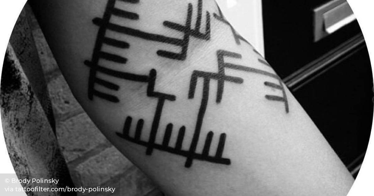 Custom geometric tattoo on the left inner elbow.