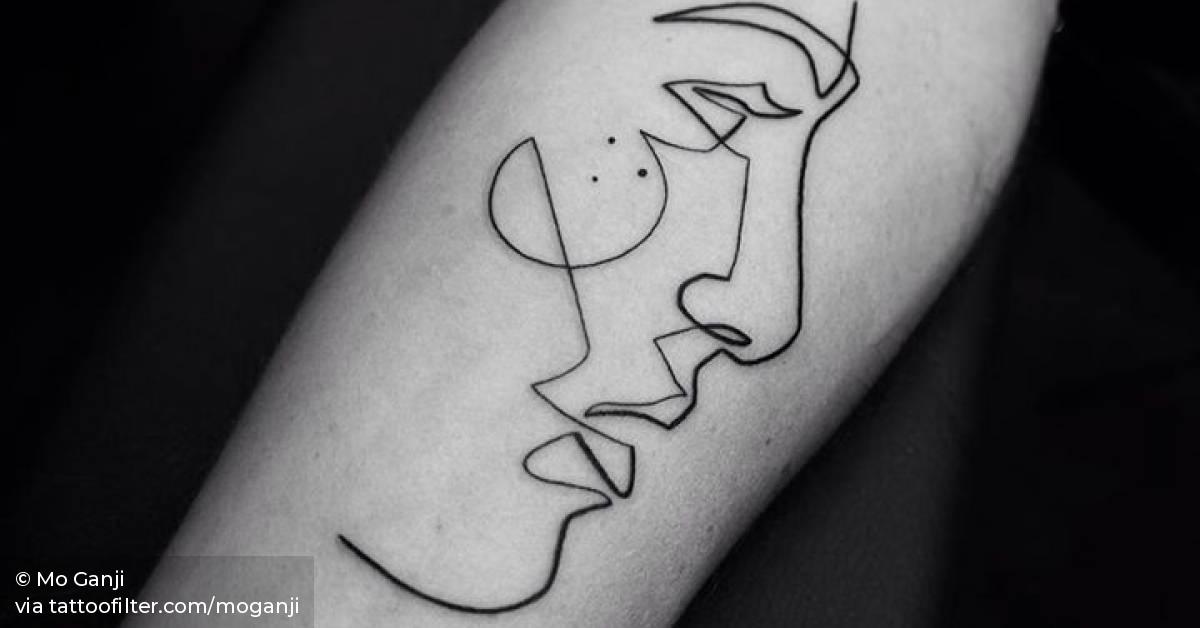 Continuous line face tattoo on the right inner forearm.