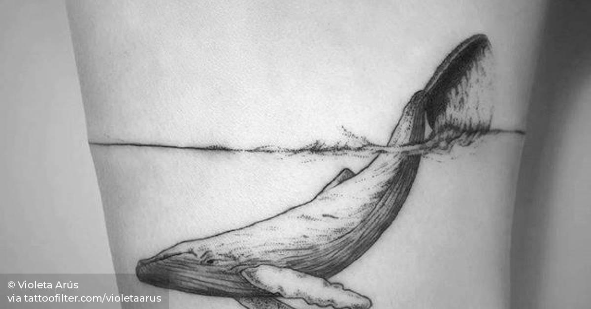 Fine line whale tattoo on the left thigh.