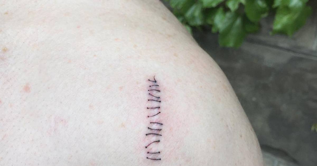 Stitch scar cover up tattoo on the left shoulder.