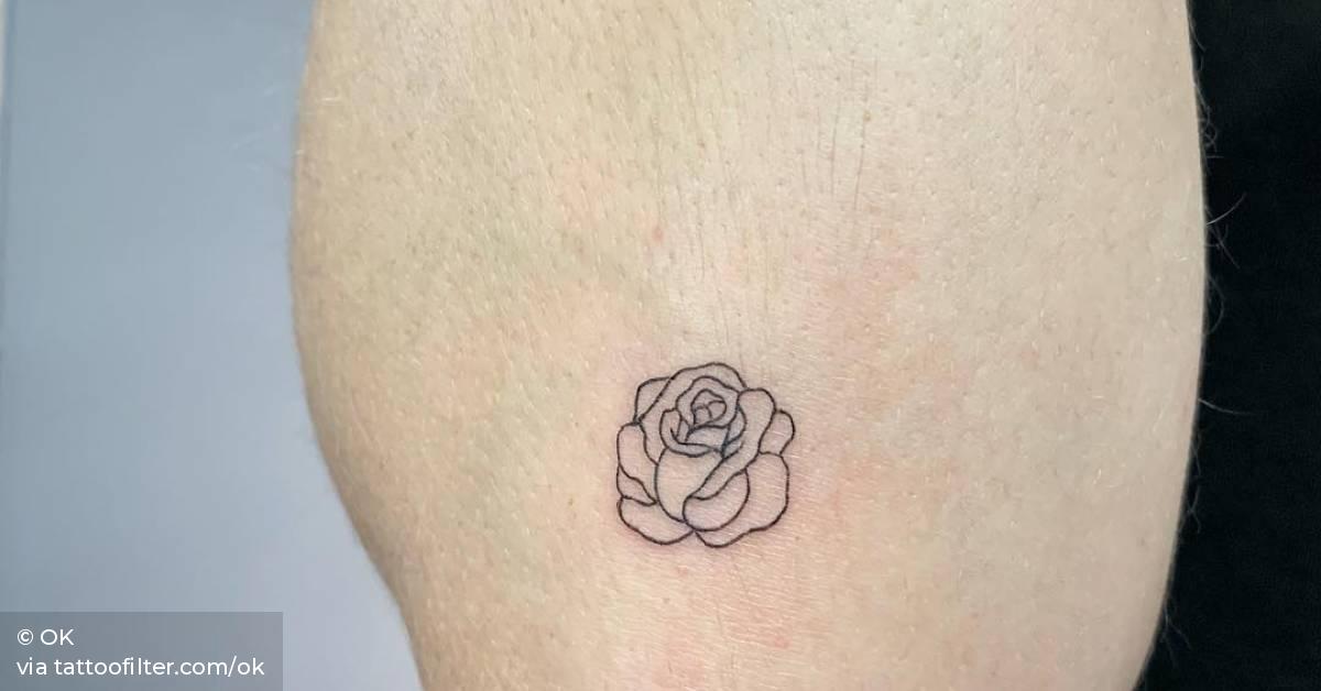 Rose head tattoo on the forearm.