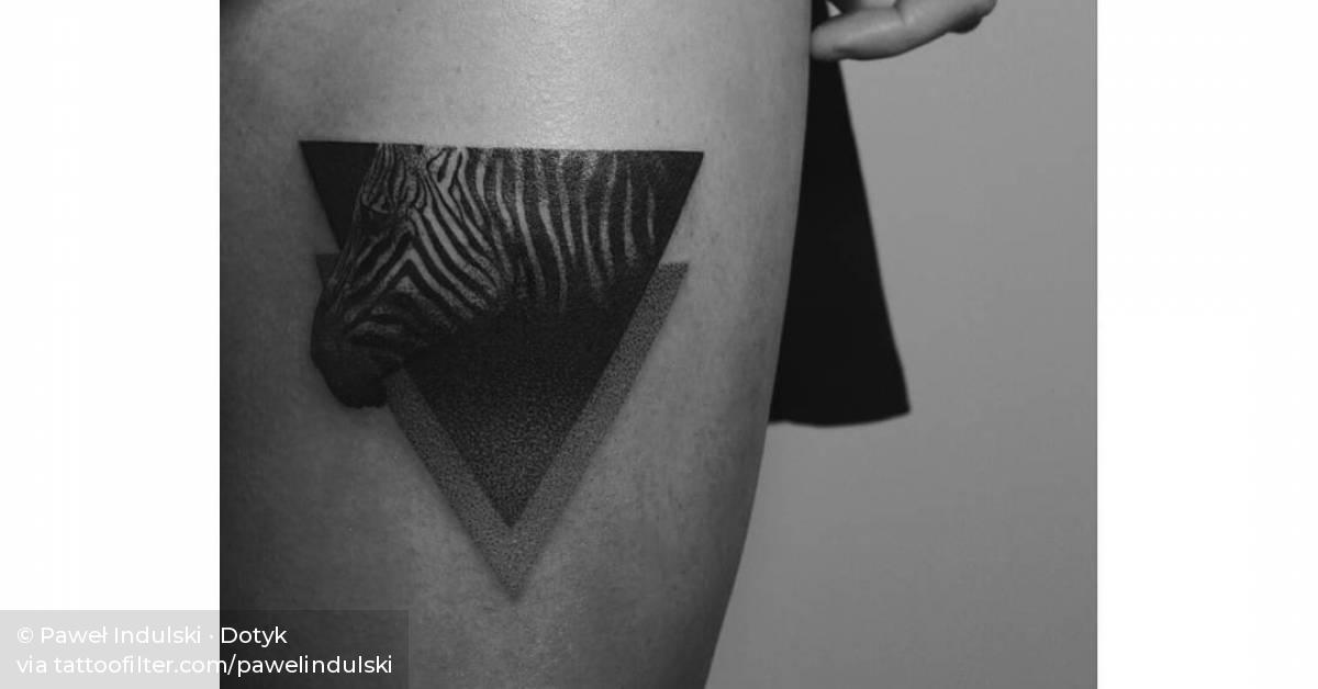 Dotwork zebra triangle tattoo on the left thigh.
