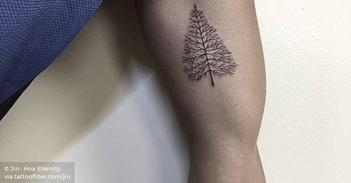 Pine tree tattoo on the inner arm.