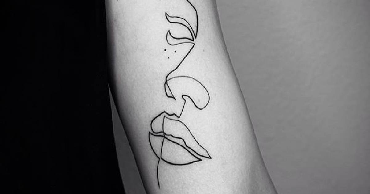 Continuous line woman face tattoo on the left inner