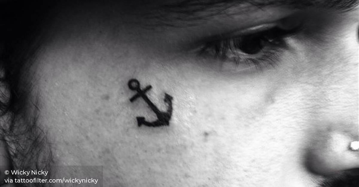 Anchor tattoo on the face.