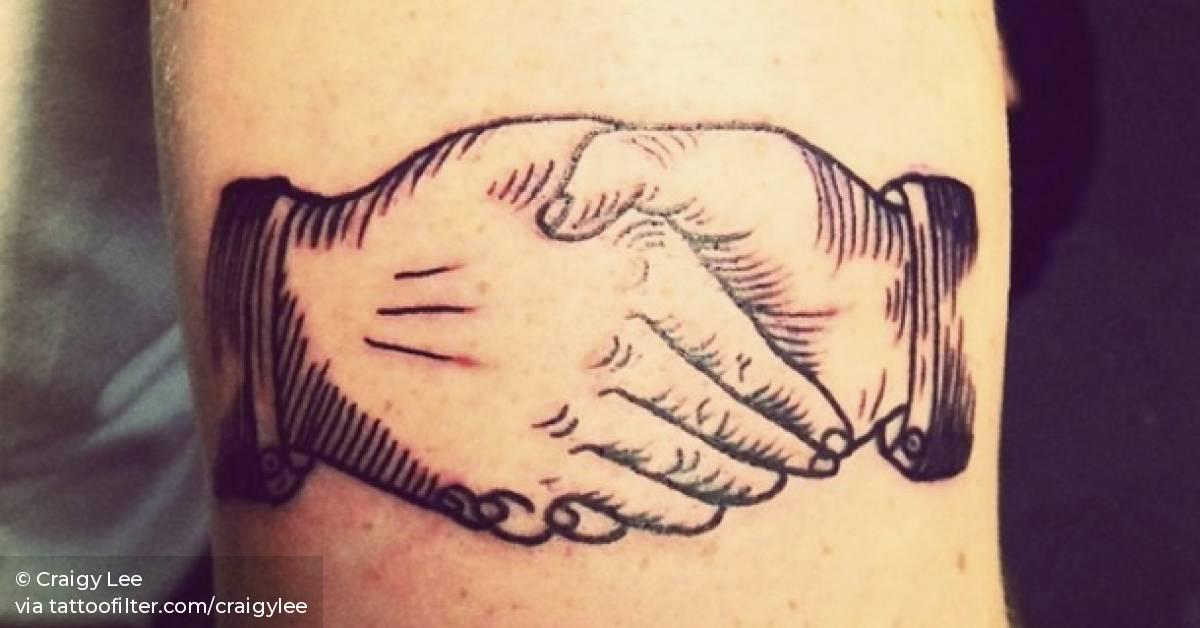 Bicep handshake tattoo by Craigy Lee.