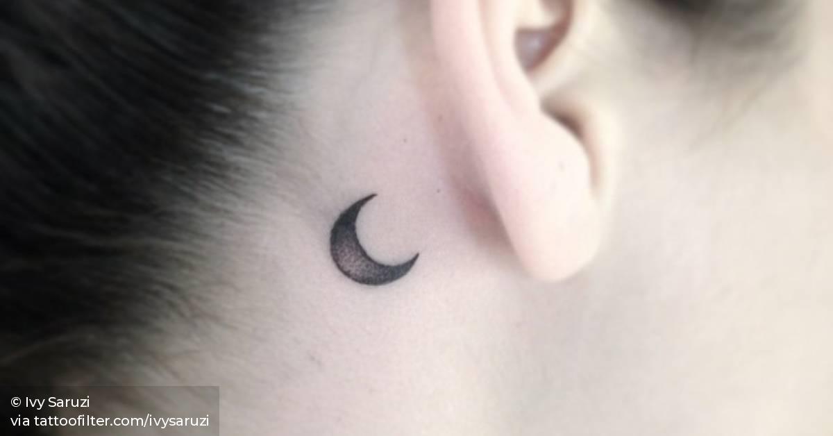 Behind the ear tattoo of a moon by Ivy Saruzi.