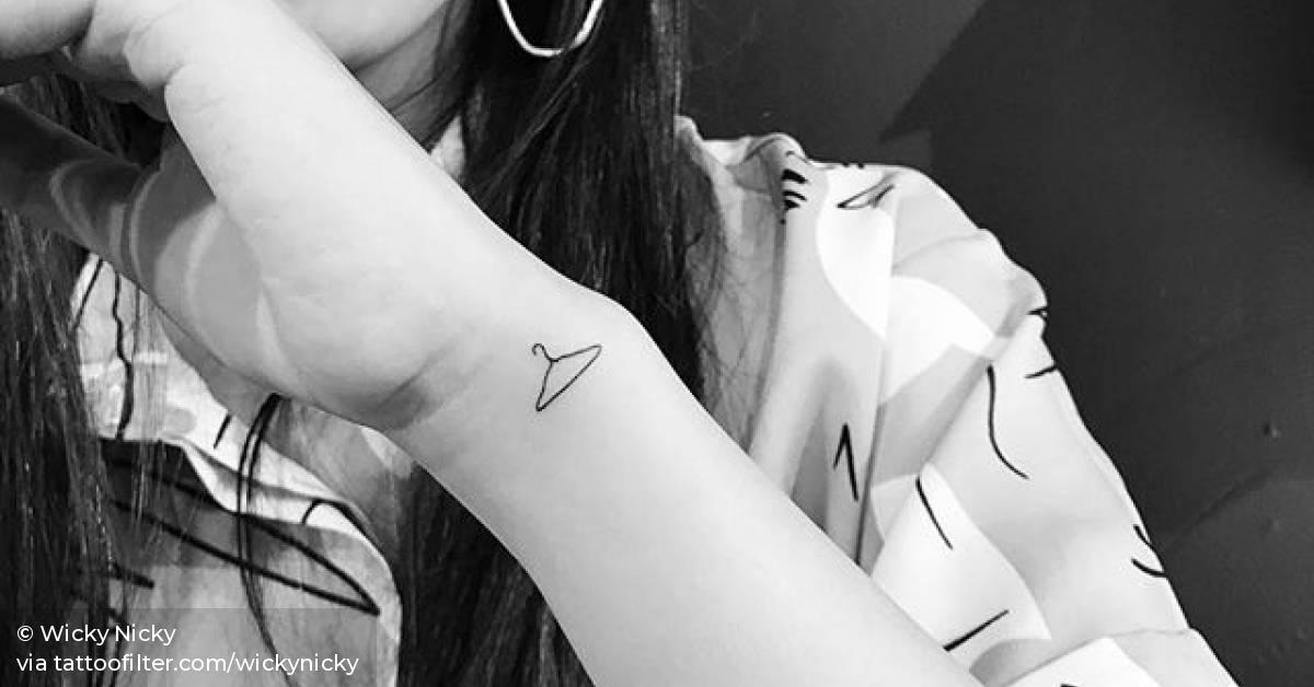 Cloth hanger tattoo on the wrist.