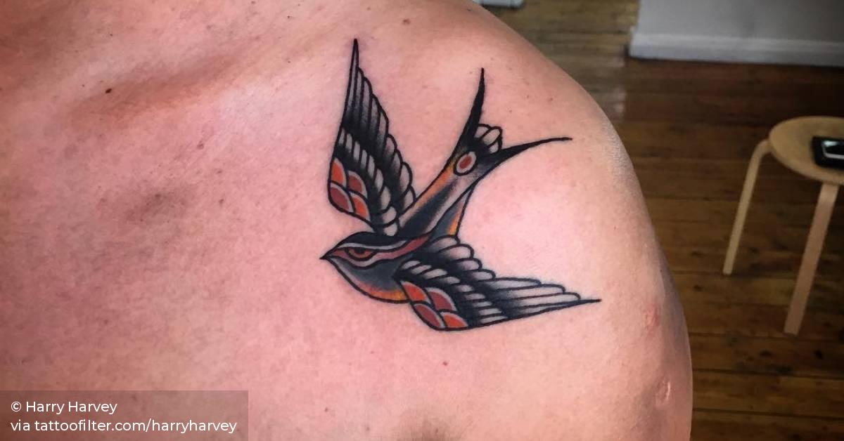Traditional swallow tattoo on the left shoulder.
