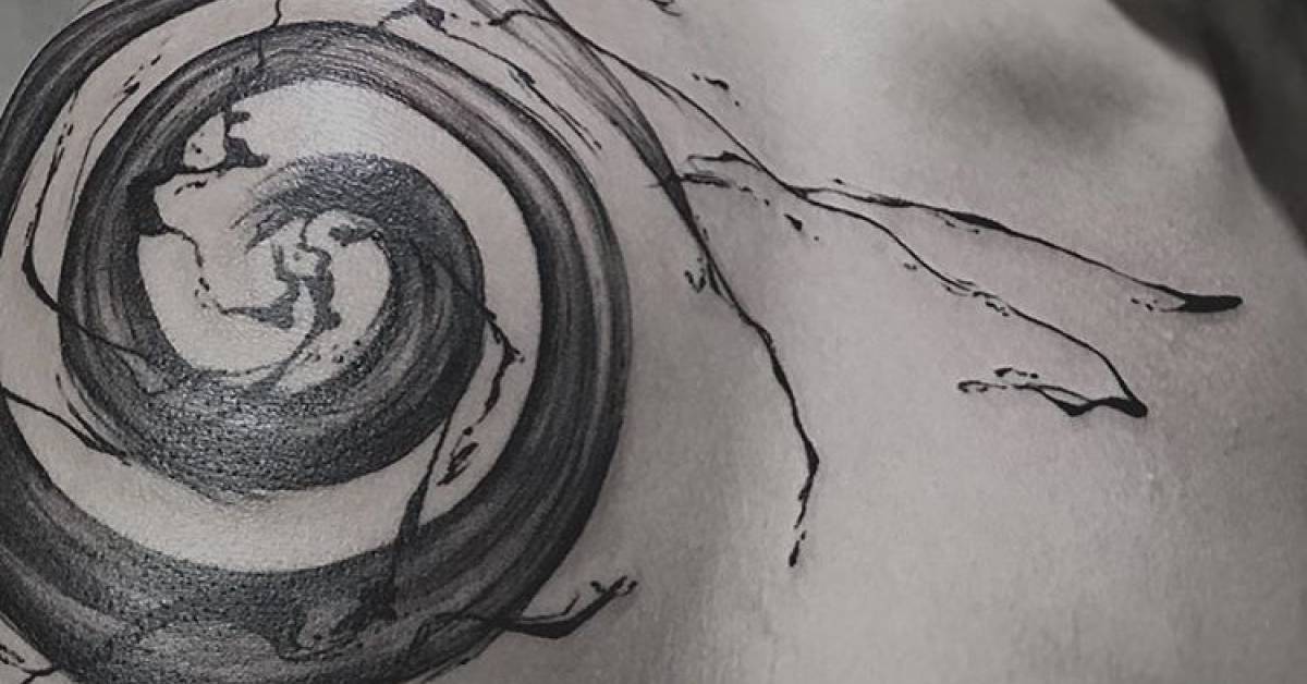 Abstract spiral tattoo on the right shoulder.