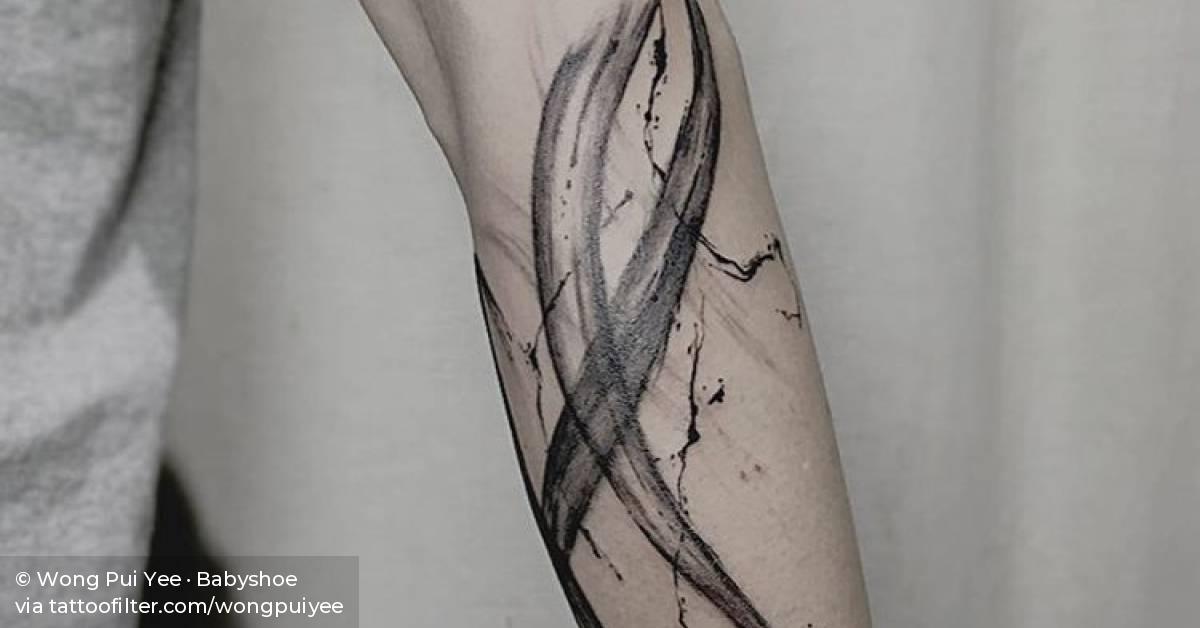 Abstract tattoo on the left arm.