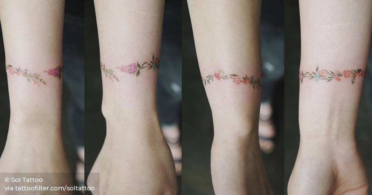 Flower wristband tattoo covering a scar.
