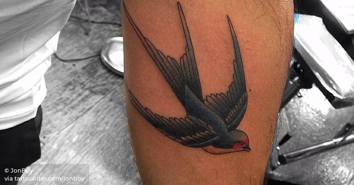 Forearm tattoo of a swallow.