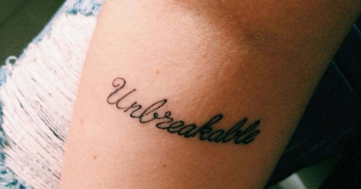 Forearm tattoo saying "Unbreakable" on Anastasia.