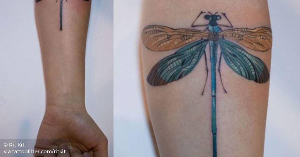 Dragonfly tattoo on the left inner forearm.