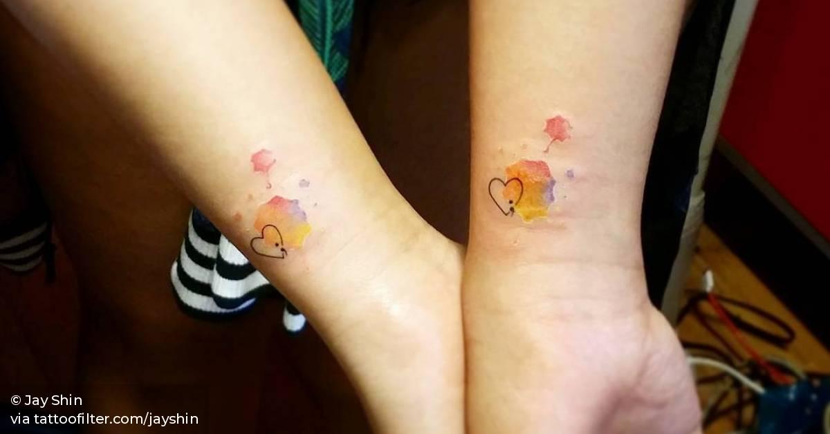Wrist matching watercolor tattoos.