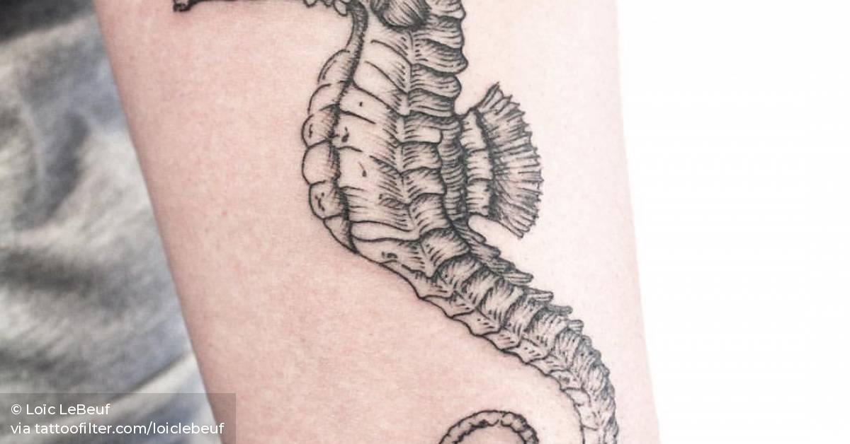 Engraving style seahorse tattoo on the left inner