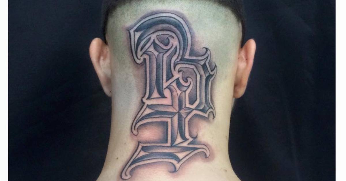 Lettering tattoo on the back of the head.