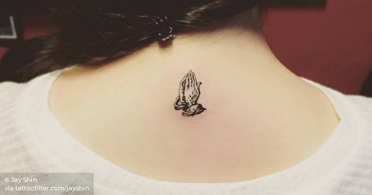 Praying hands on the upper back.