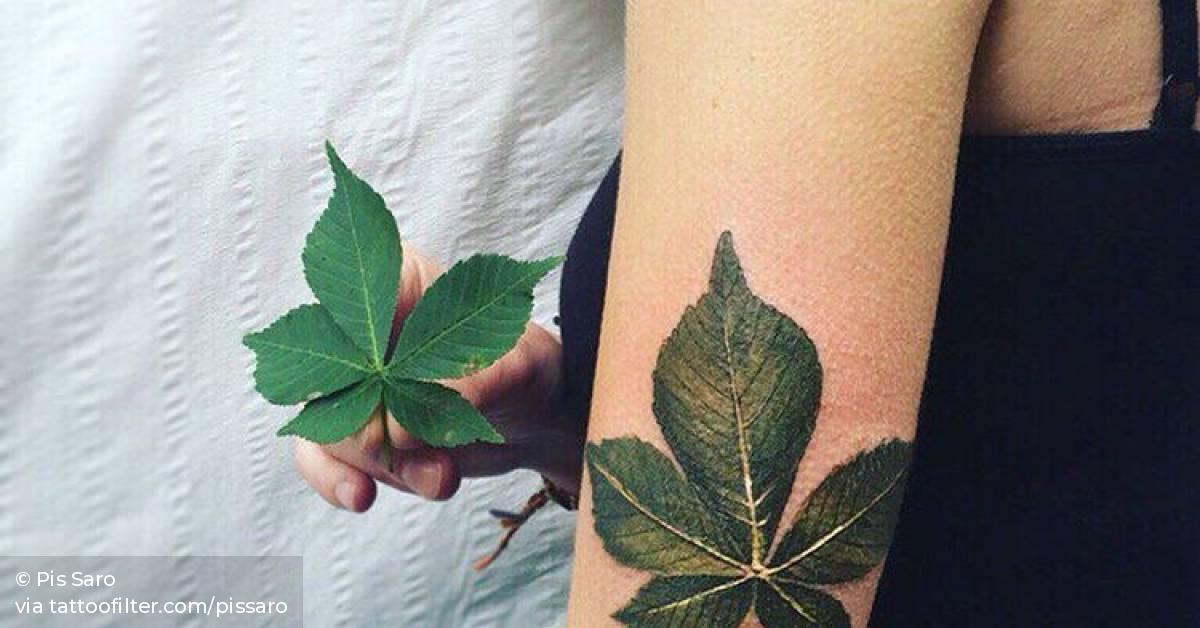 Chestnut leaf tattoo on the back of the left arm.