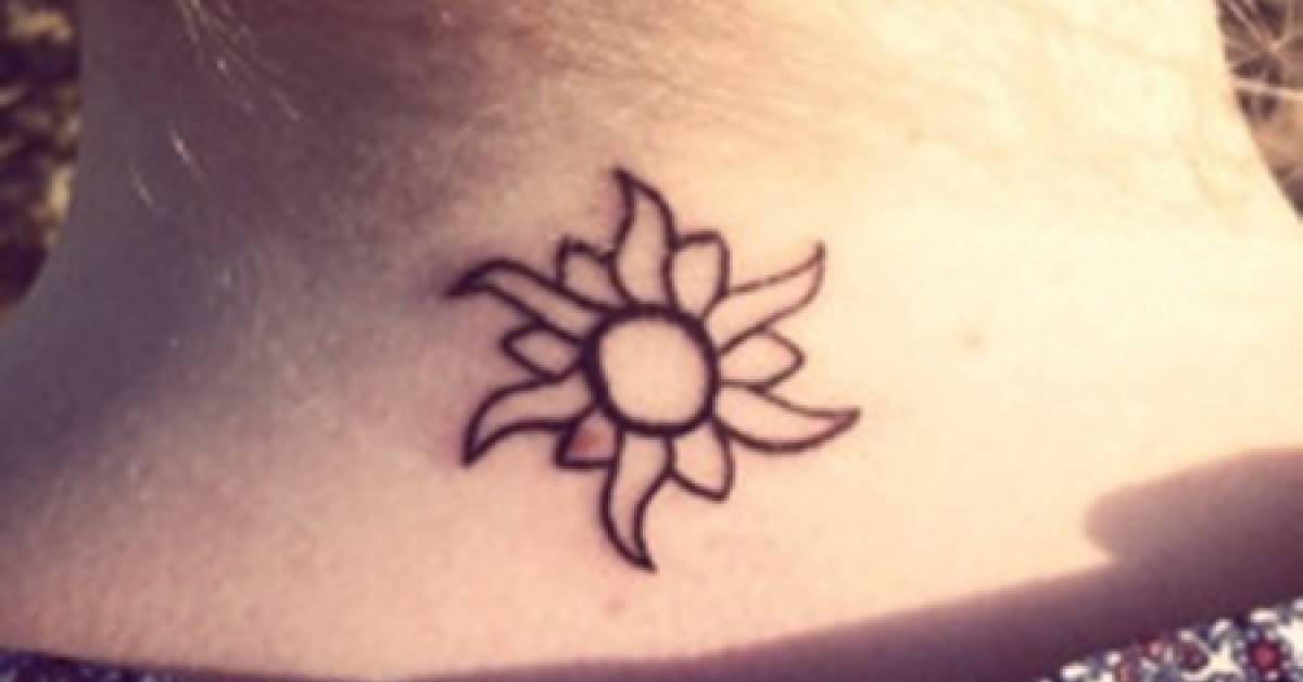 Sun tattoo on the back of the neck.