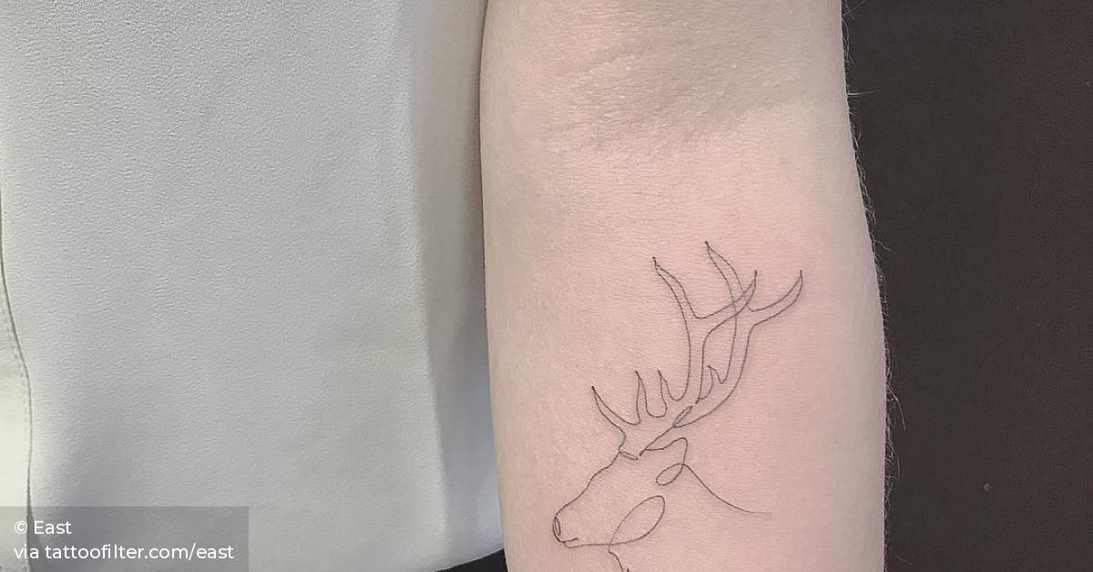 Continuous line deer tattoo on the inner forearm.