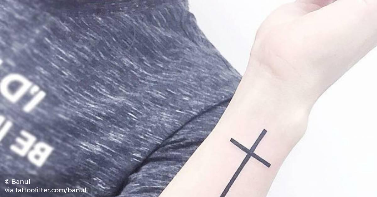 Christian cross tattoo on the wrist.