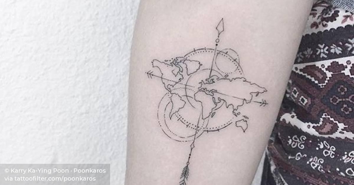World map compass tattoo on the right inner forearm.