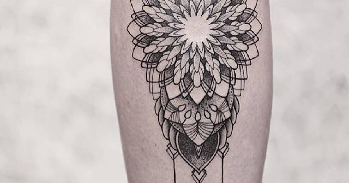 Mandala tattoo on the left calf.