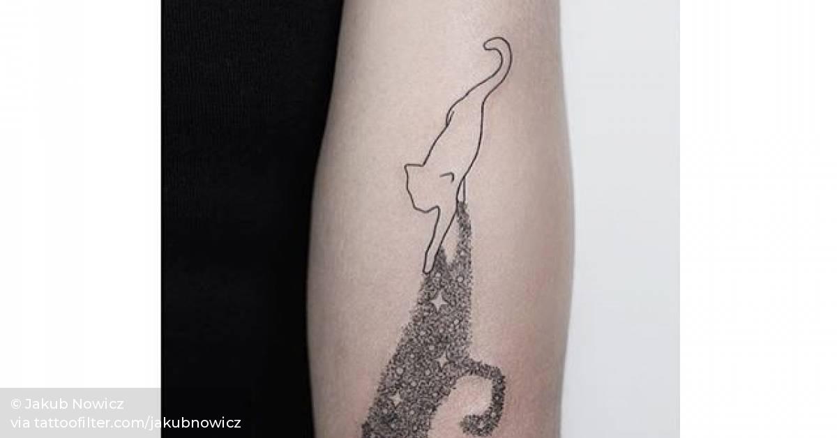 Cat and its shadow tattoo on the back of the right arm.