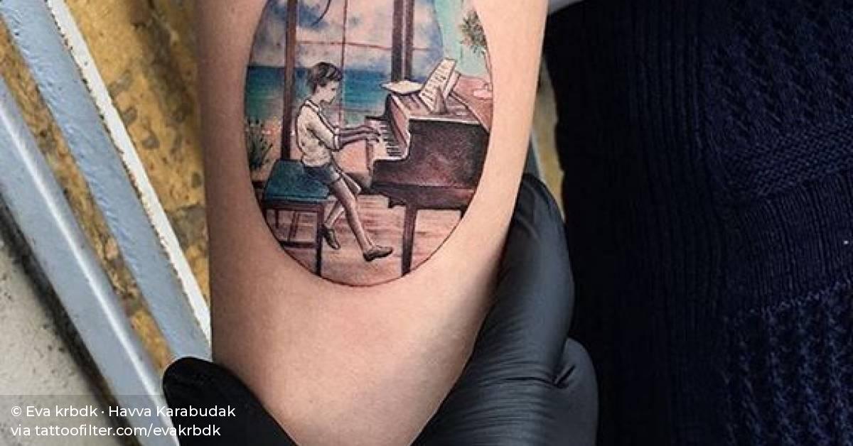 Piano player tattoo on the right inner forearm.