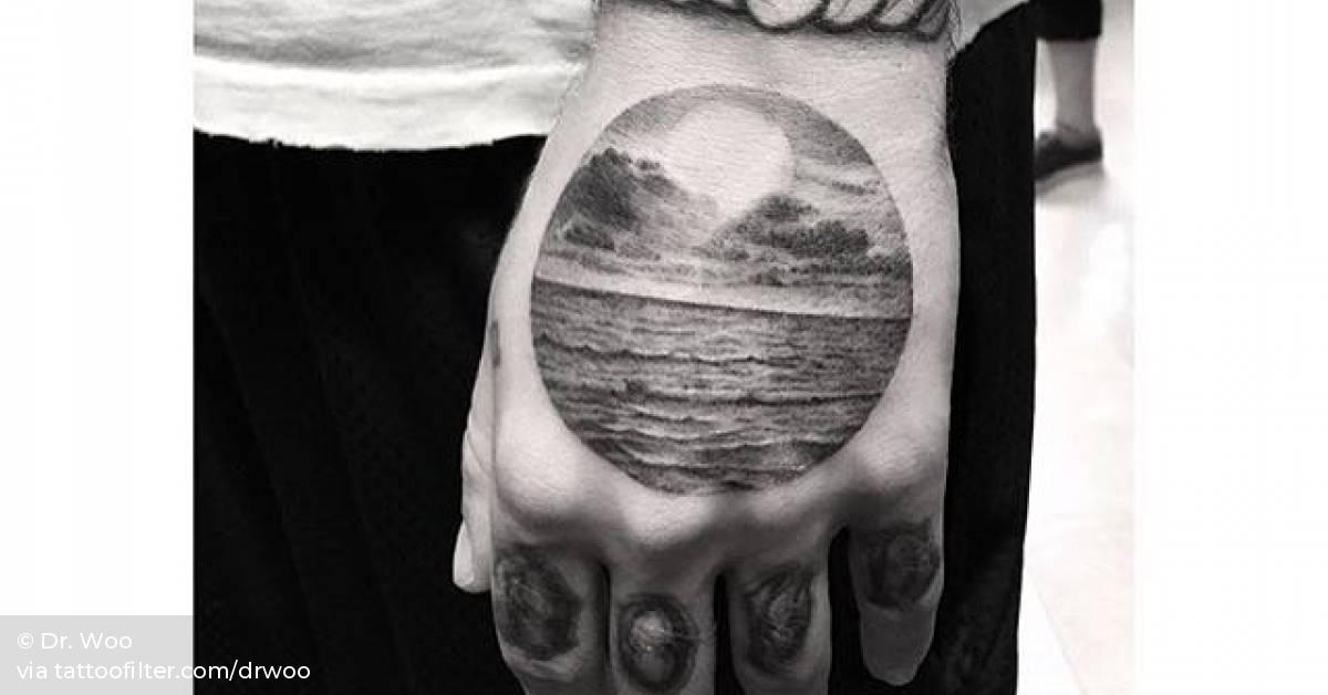 Sea landscape circle tattoo on the hand.