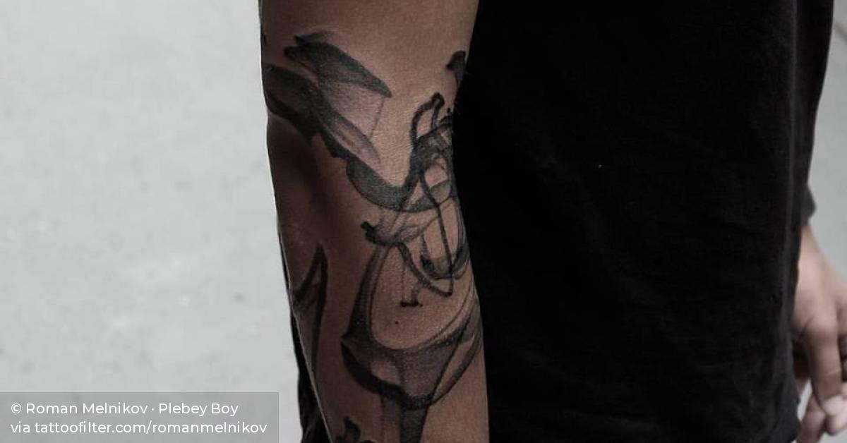 Abstract tattoo on the right arm.