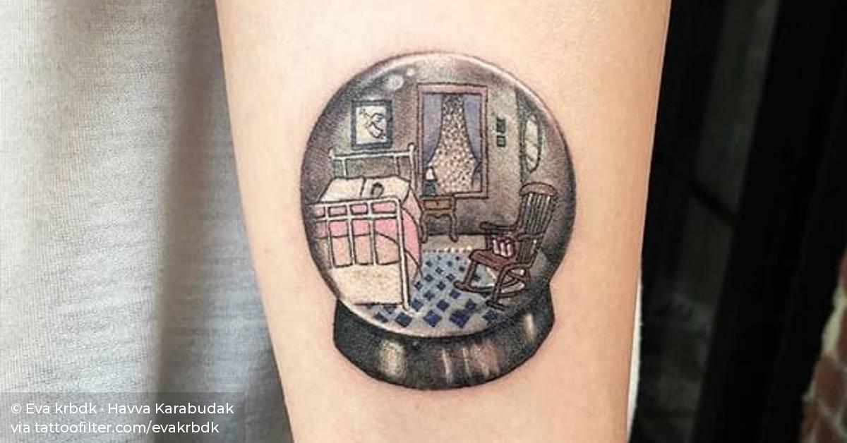 Snow globe tattoo on the left inner forearm.