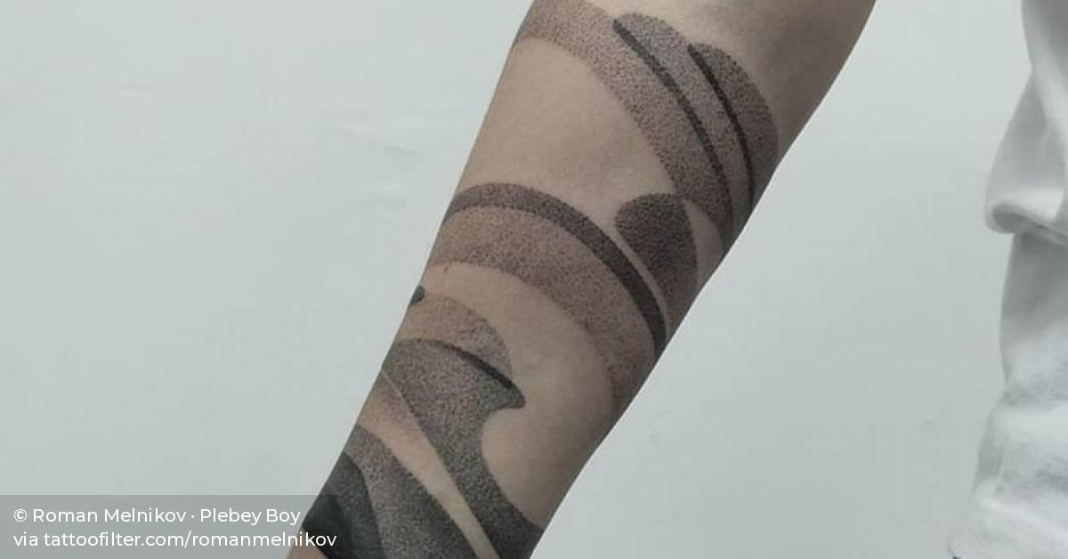 Abstract dotwork tattoo on the right forearm.