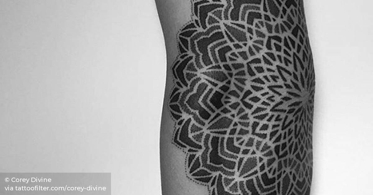 Mandala tattoo on the elbow.