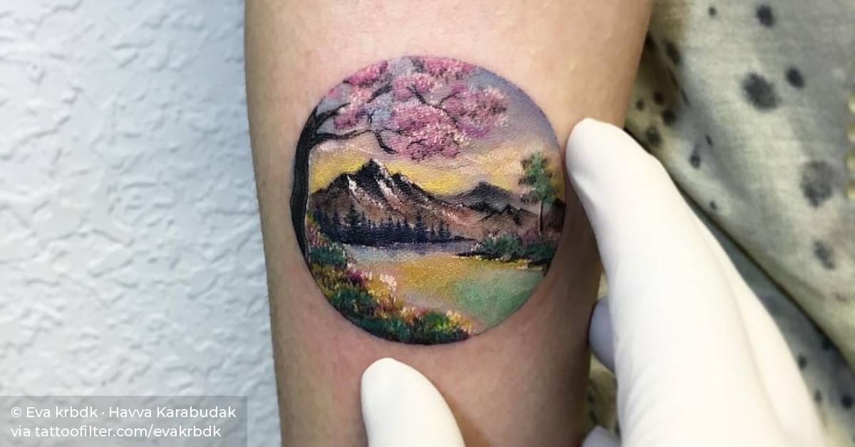 Landscape tattoo on the right inner forearm.