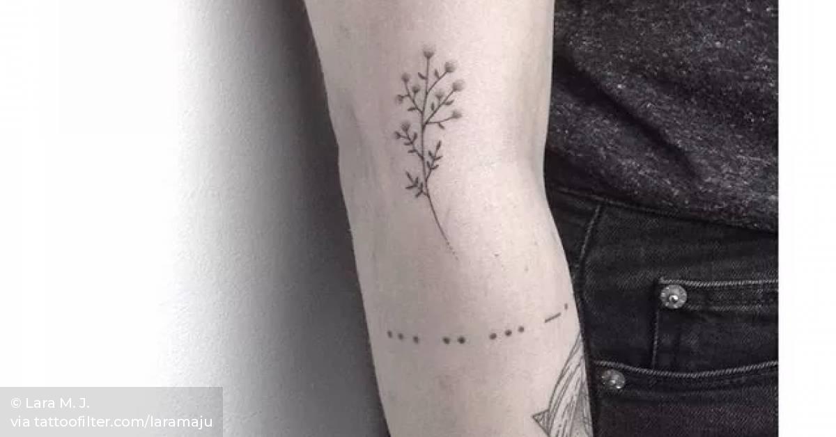 Hand poked twig tattoo on the elbow.