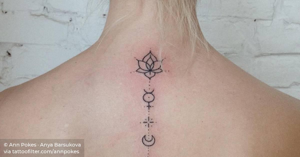 Hand poked minimalist tattoo on the upper back.