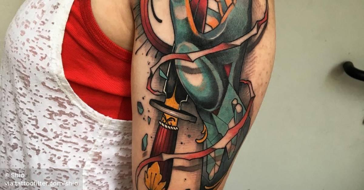 Neotraditional hand and dagger tattoo on the left upper