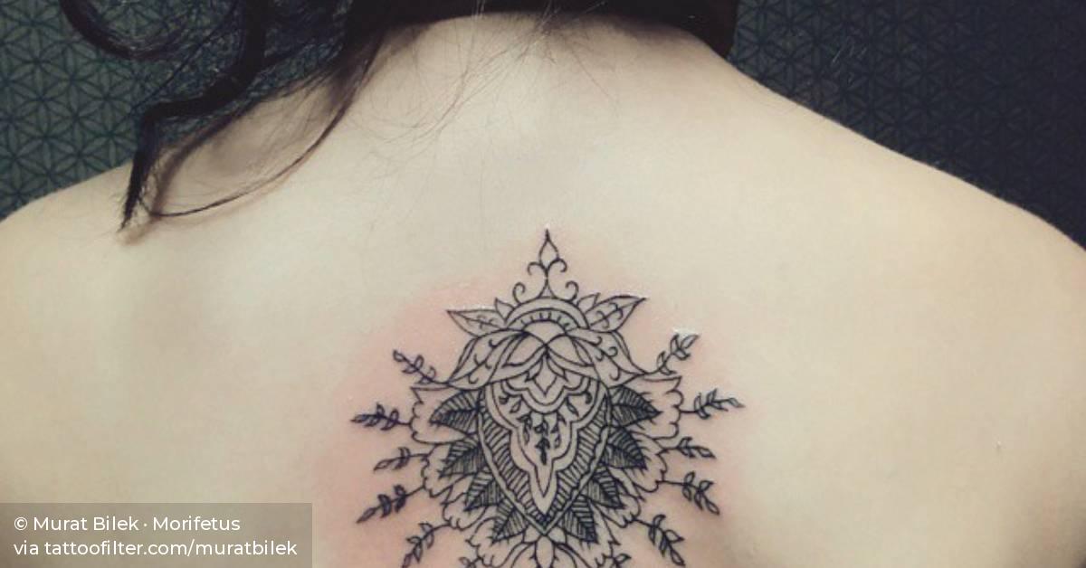 Ornamental style tattoo on the upper back. Original