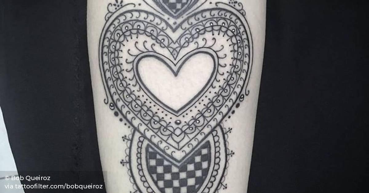 Ornamental heart tattoo on the inner forearm.